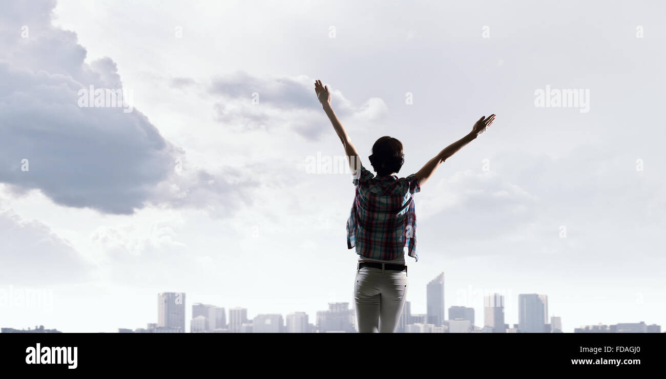 Back view of cheerful woman with hands up facing sunrise Stock Photo ...