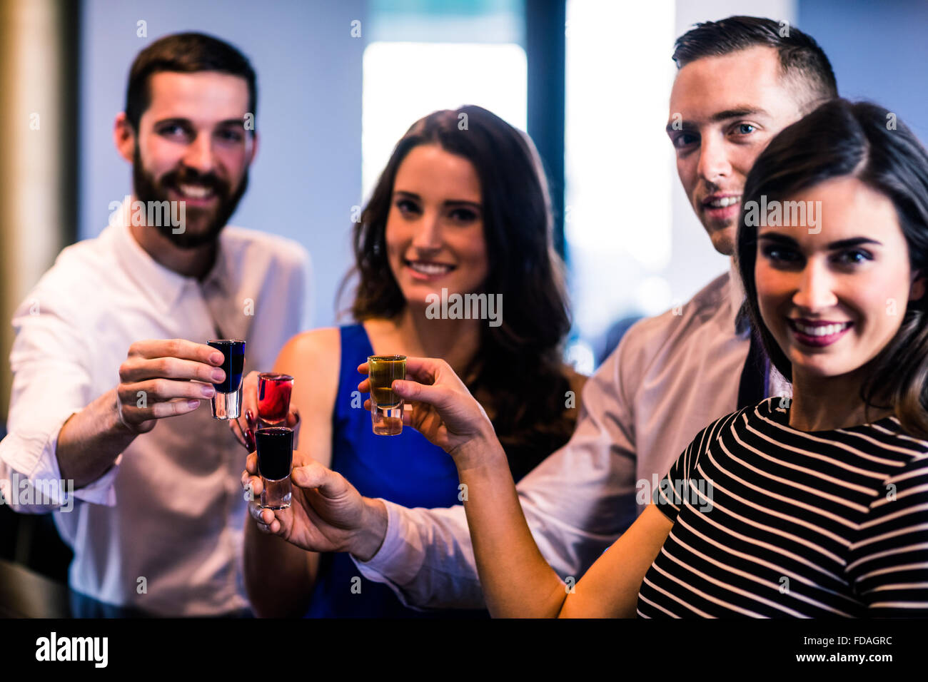 Friends toasting with alcohol shots Stock Photo - Alamy