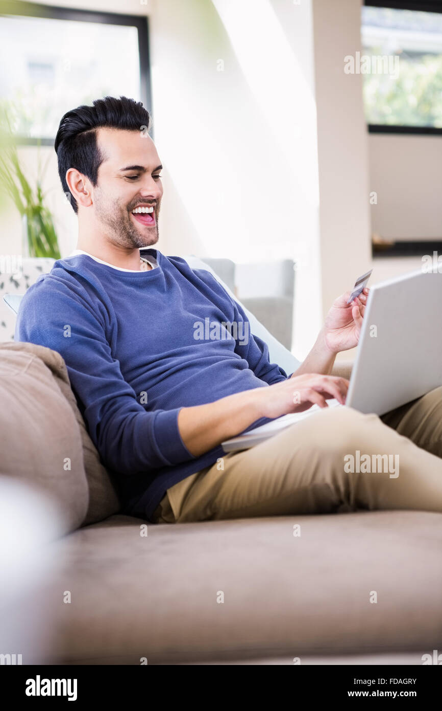 Handsome man doing shopping online Stock Photo - Alamy
