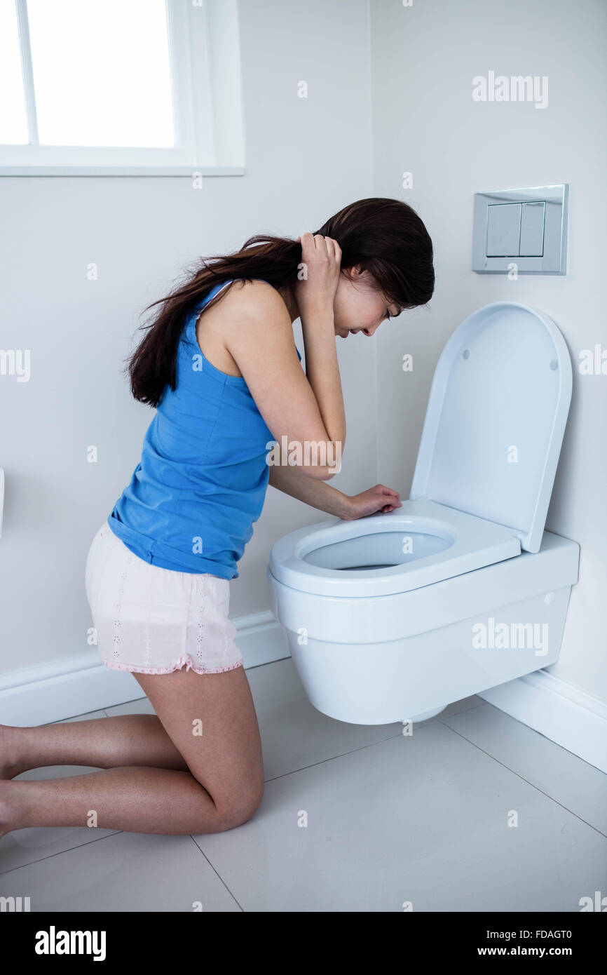 Rear view of woman throwing up Stock Photo - Alamy