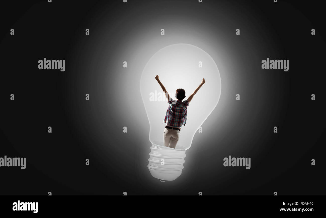 Back view of girl inside of light bulb Stock Photo - Alamy