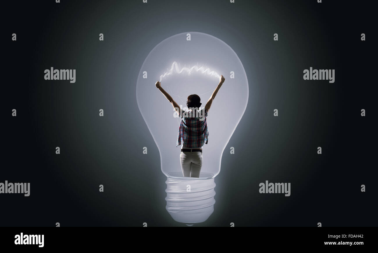Back view of girl inside of light bulb Stock Photo - Alamy