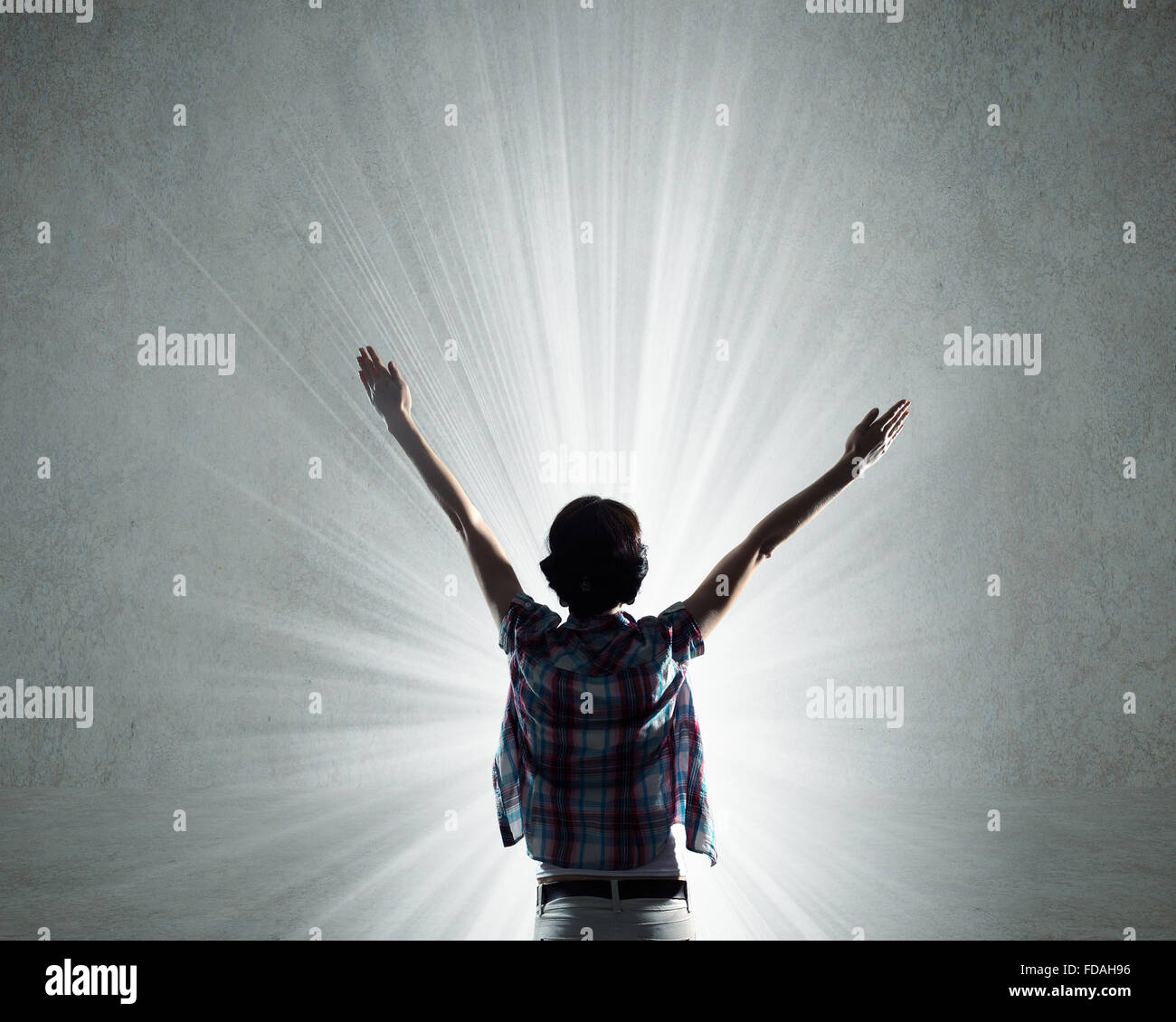 Rear view of woman with hands up facing success Stock Photo - Alamy