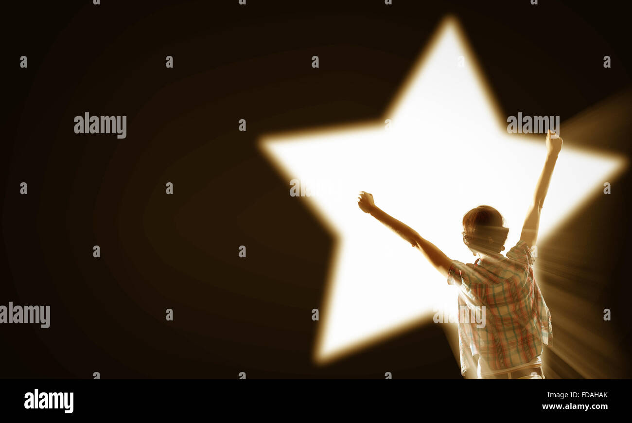 Rear view of woman with hands up facing success Stock Photo - Alamy