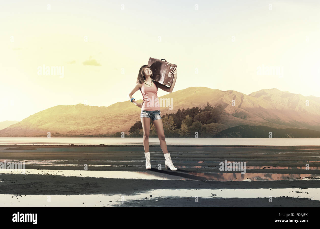 Young retro woman with her vintage baggage on shoulder Stock Photo - Alamy