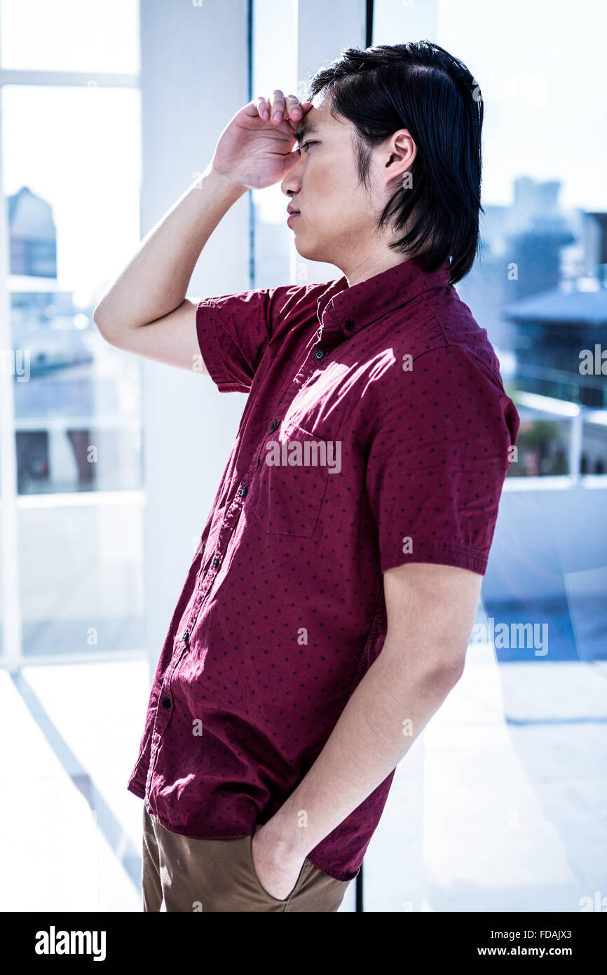 Worried creative businessman leaning on wall Stock Photo - Alamy