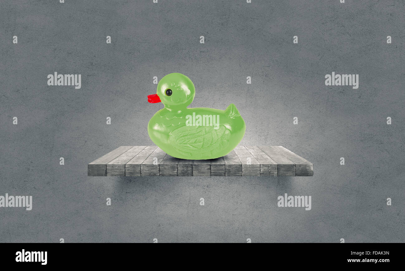 Green rubber duck toy on wooden board Stock Photo - Alamy