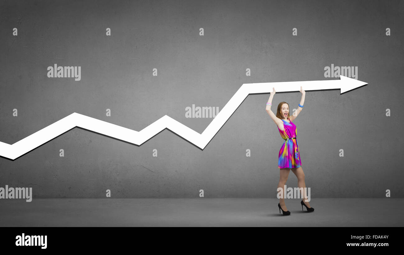 Woman in multicolored dress with arrow graph in hands Stock Photo - Alamy