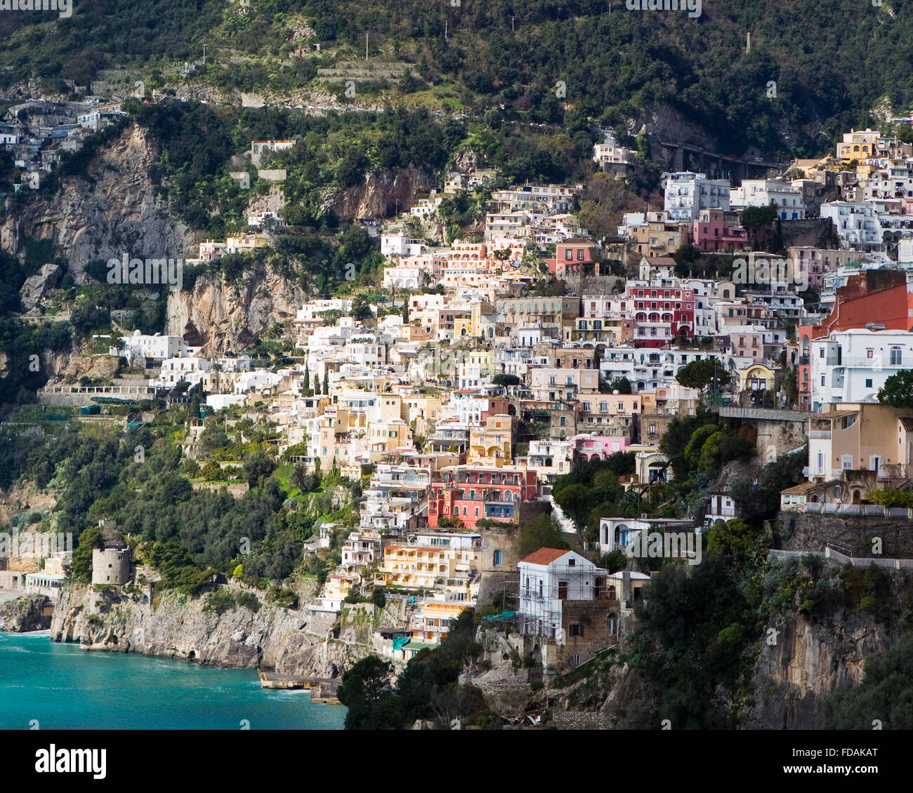 Pastel coloured houses cling to the mountain above Positano Stock Photo ...