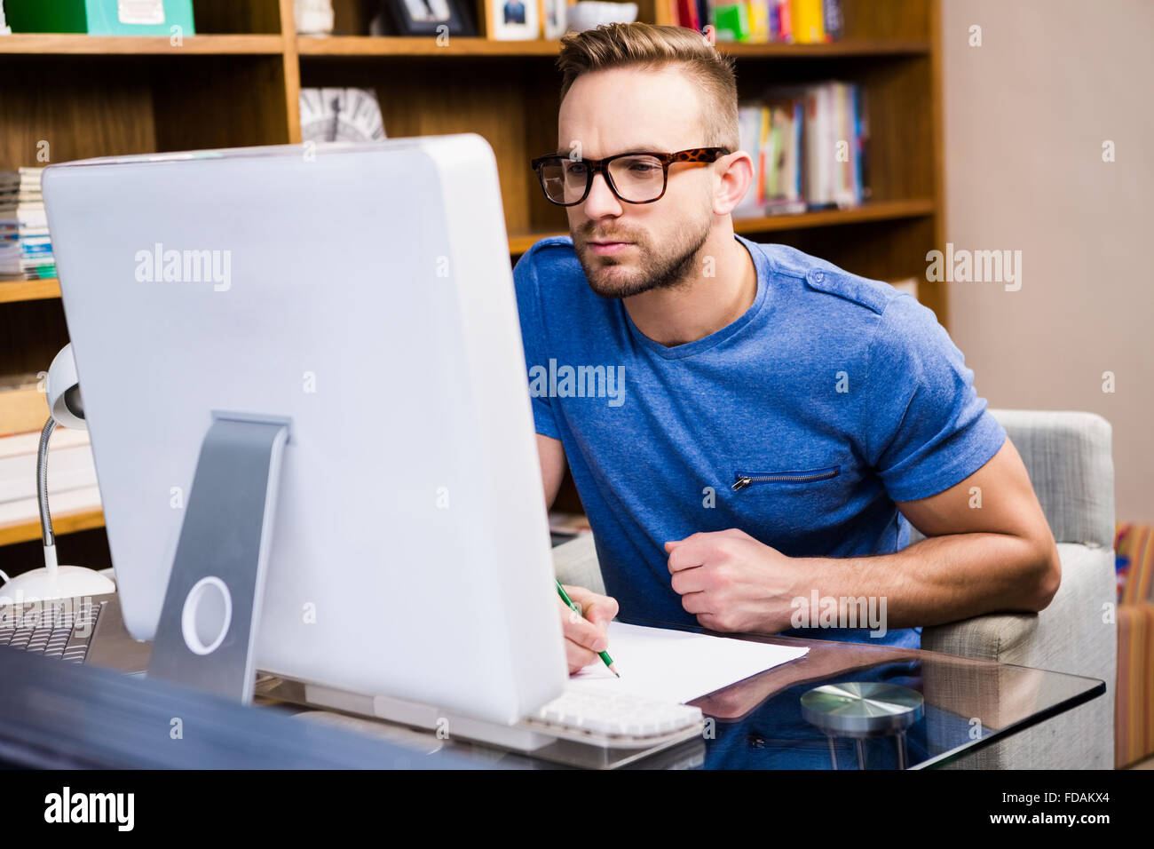 Serious designer drawing at desk Stock Photo - Alamy