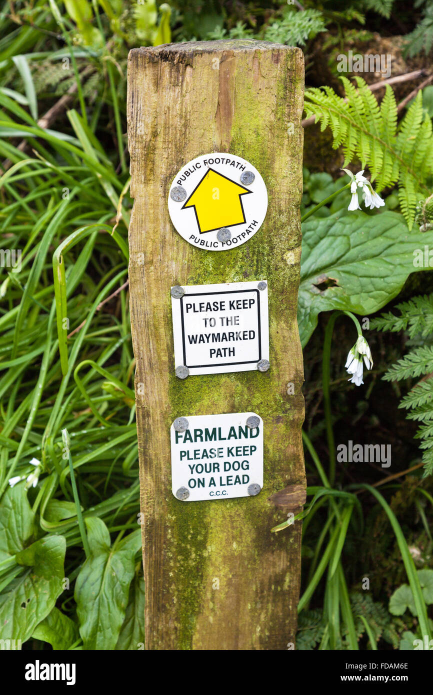 A public footpath sign saying please keep to the waymarked path and ...