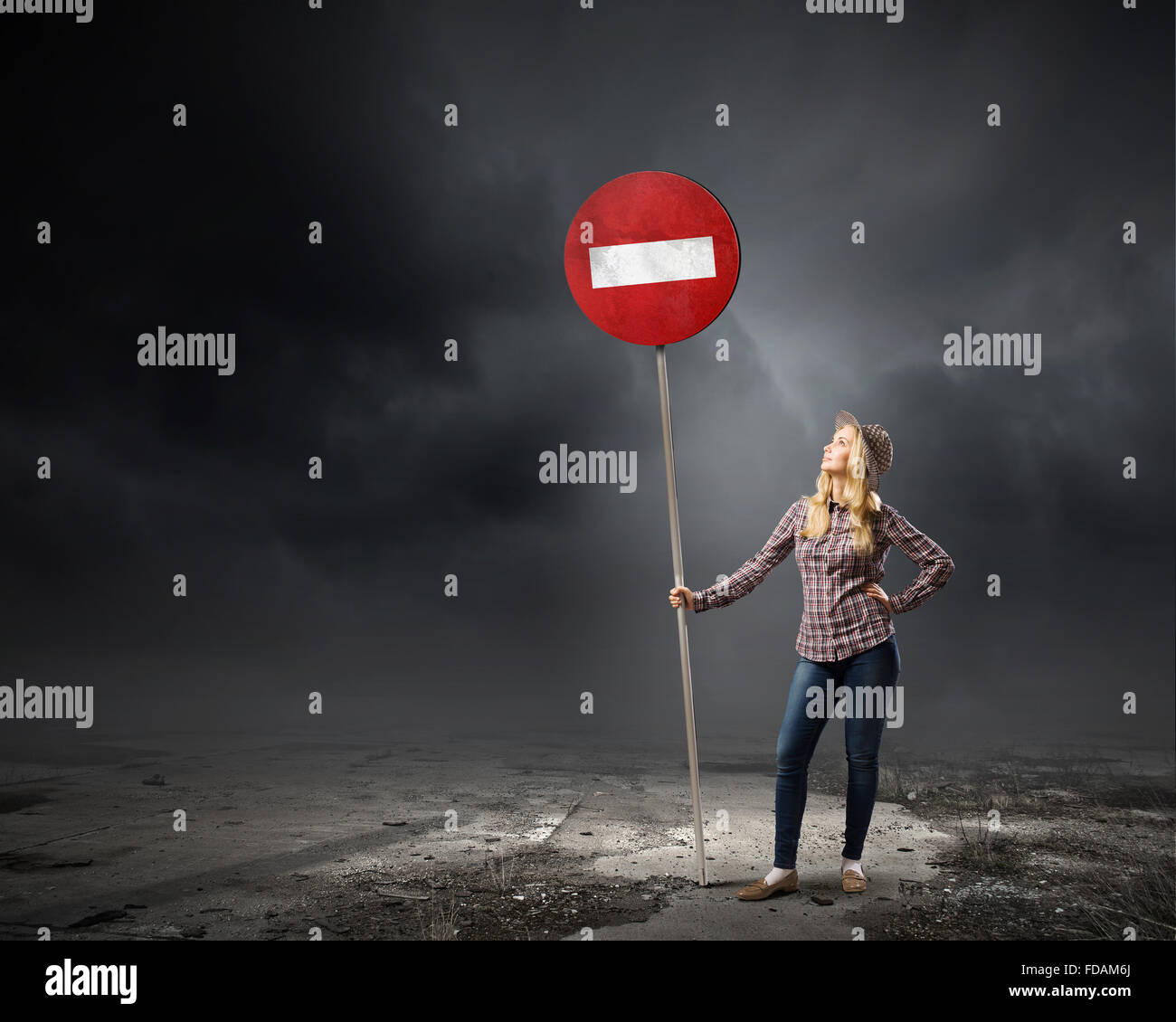 Young girl in casual holding stop sign Stock Photo - Alamy