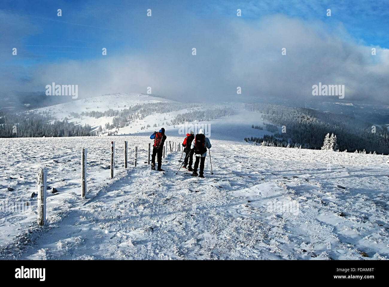 snowshoers on winter Fischbacher Alpen mountains bellow Stuhleck resort ...
