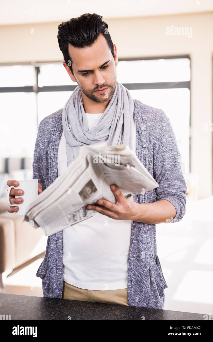 Handsome man reading newspaper Stock Photo - Alamy