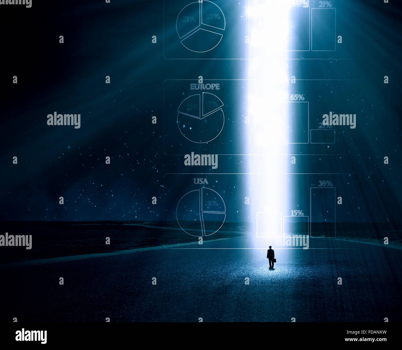 Rear view of businessman standing in light going from above Stock Photo ...
