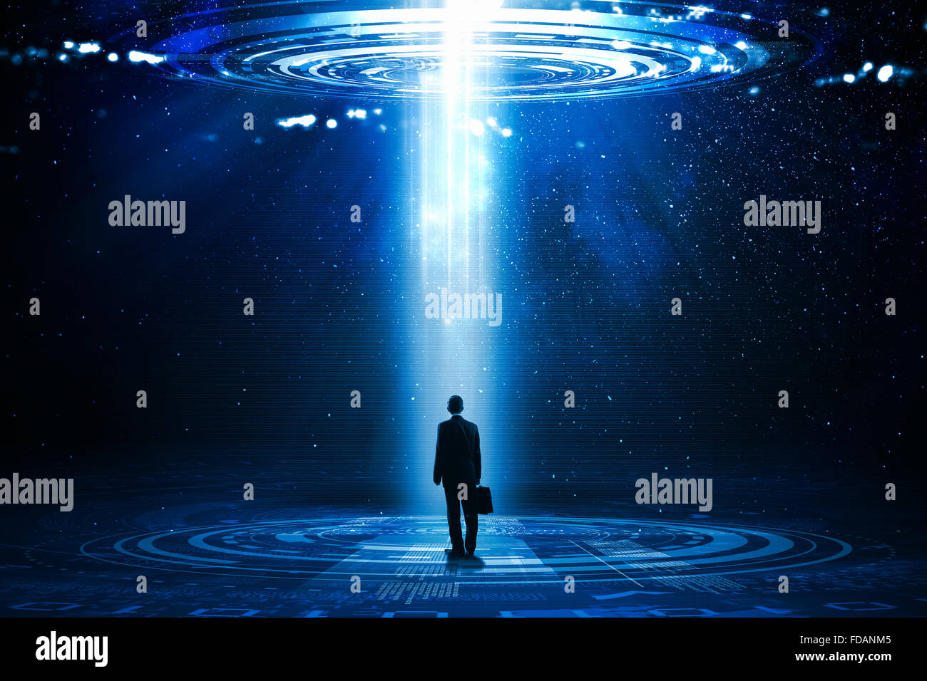 Rear view of businessman standing in light going from above Stock Photo ...