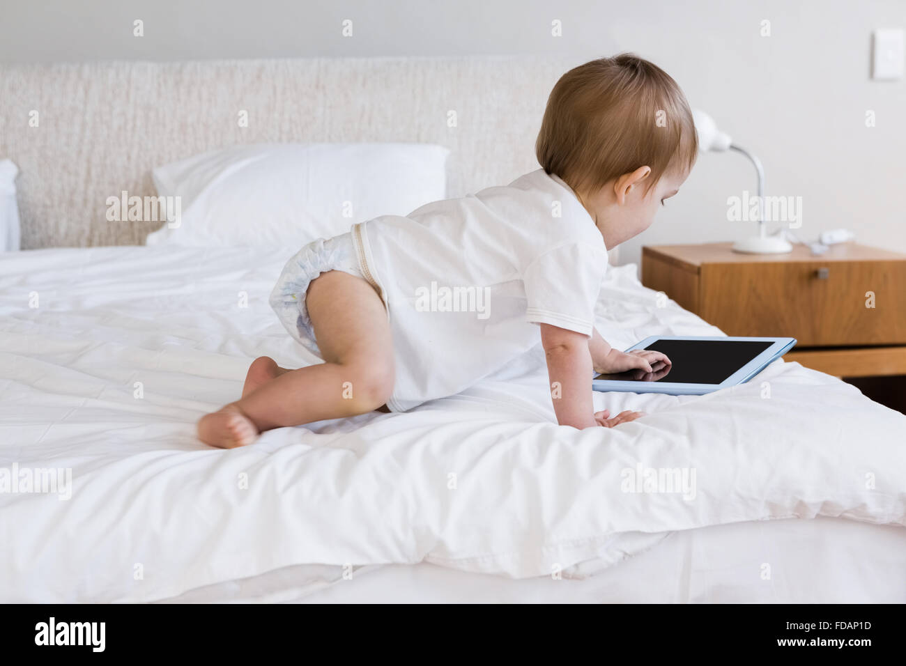 Cute baby using tablet Stock Photo - Alamy