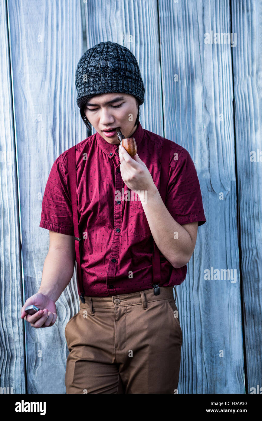 Hipster smoking pipe with a lighter Stock Photo - Alamy