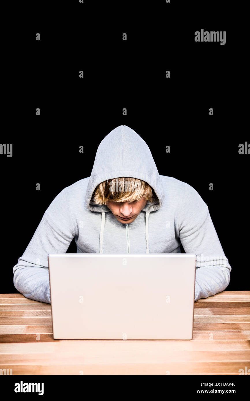 Man in hood jacket hacking a laptop Stock Photo - Alamy