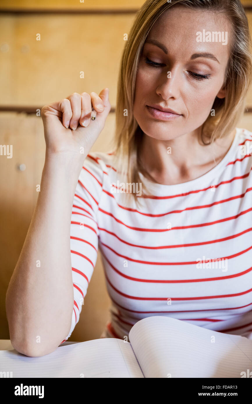 Female student taking notes in a class Stock Photo - Alamy