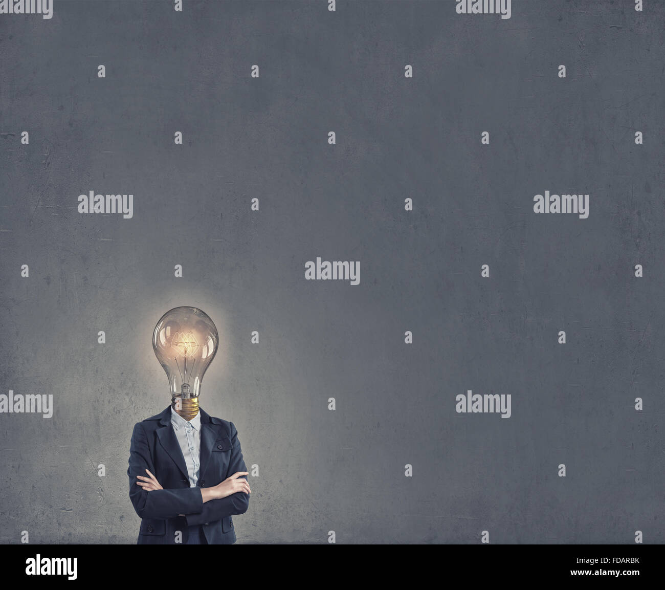 Businesswoman in suit with light bulb instead of head Stock Photo - Alamy