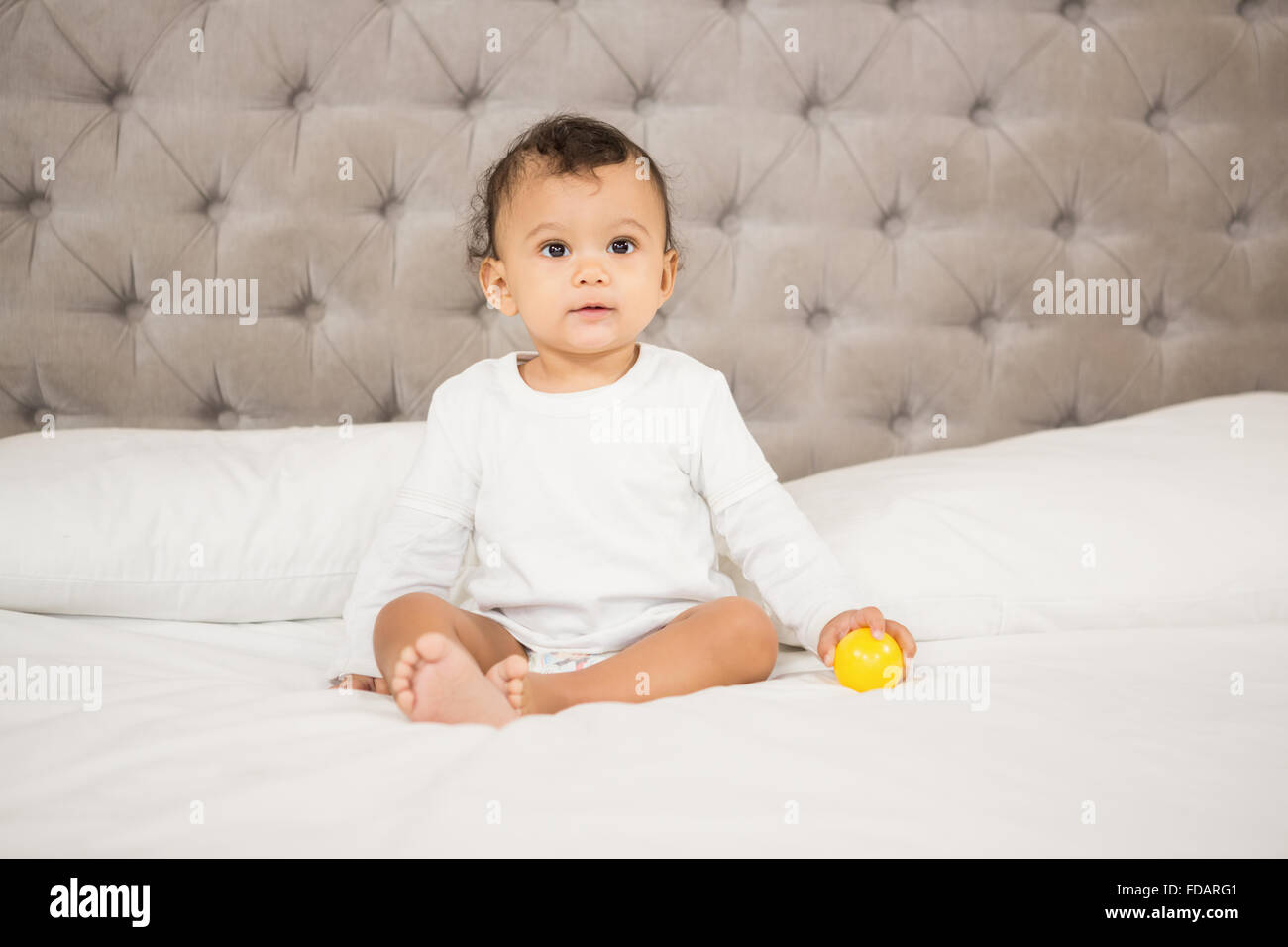 Cute baby playing with ball Stock Photo - Alamy