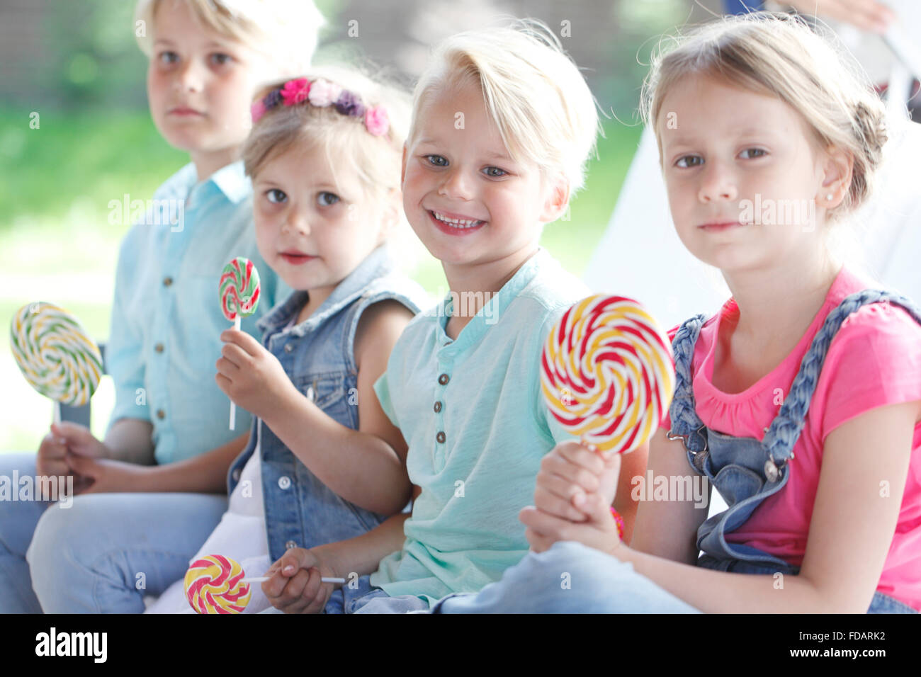 Group of happy smiling children with lollipops outdoors Stock Photo - Alamy