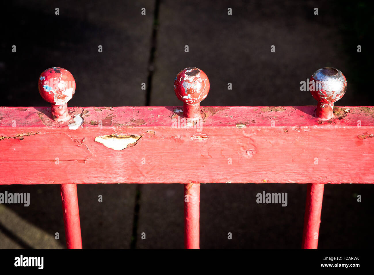 Part of a red metal railing Stock Photo - Alamy
