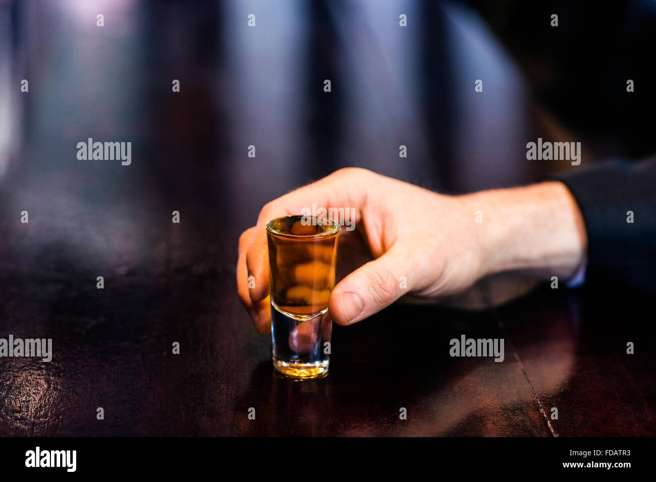 Man holding a shot Stock Photo - Alamy