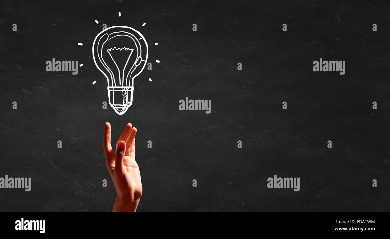 Human hand and light bulb drawn with chalk Stock Photo - Alamy