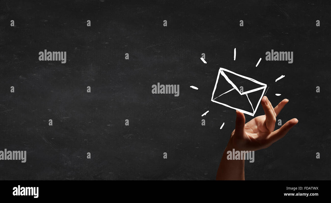 Person hand taking chalk drawn email sign Stock Photo - Alamy