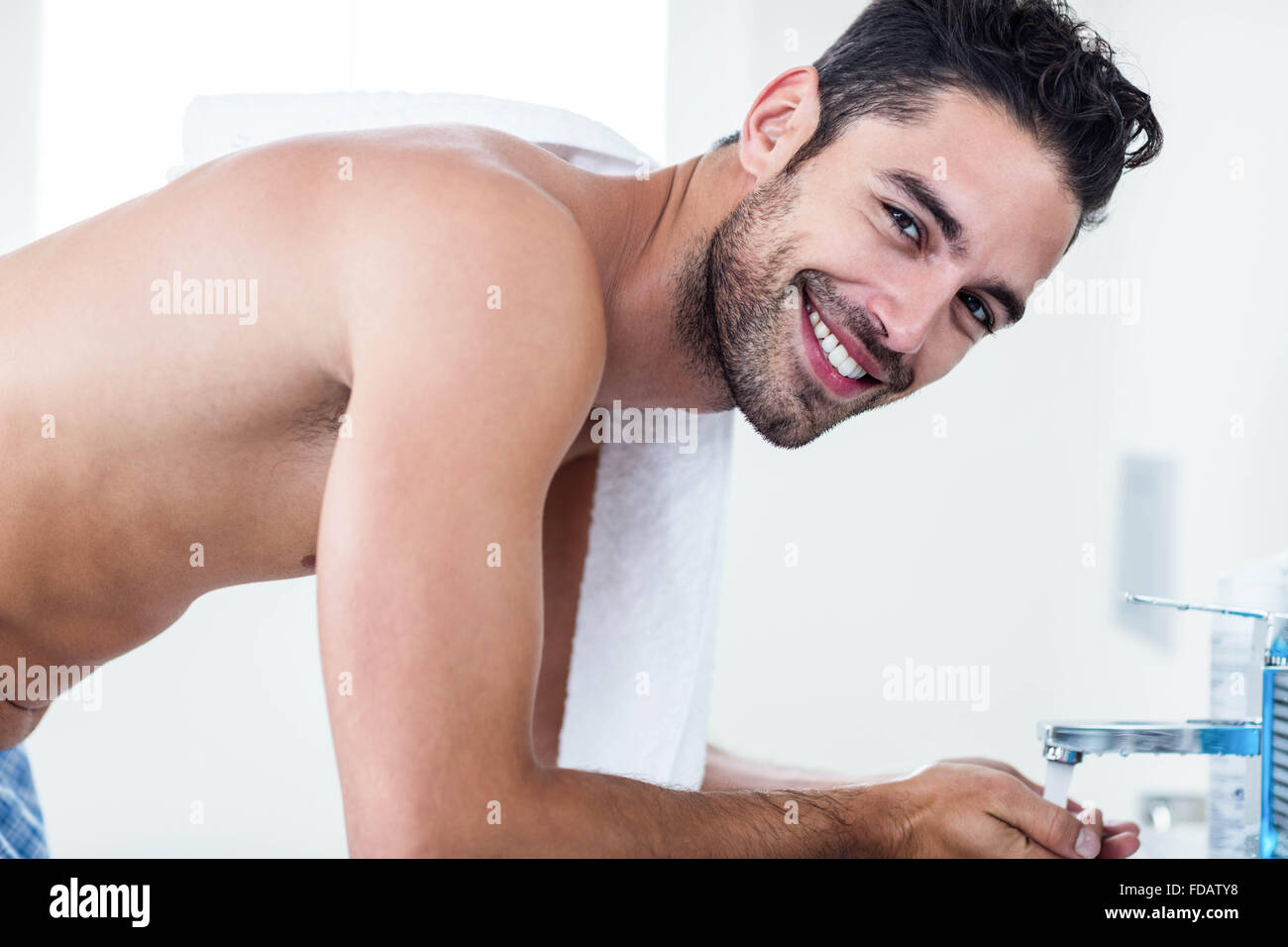 Man washing his face in sink Stock Photo - Alamy
