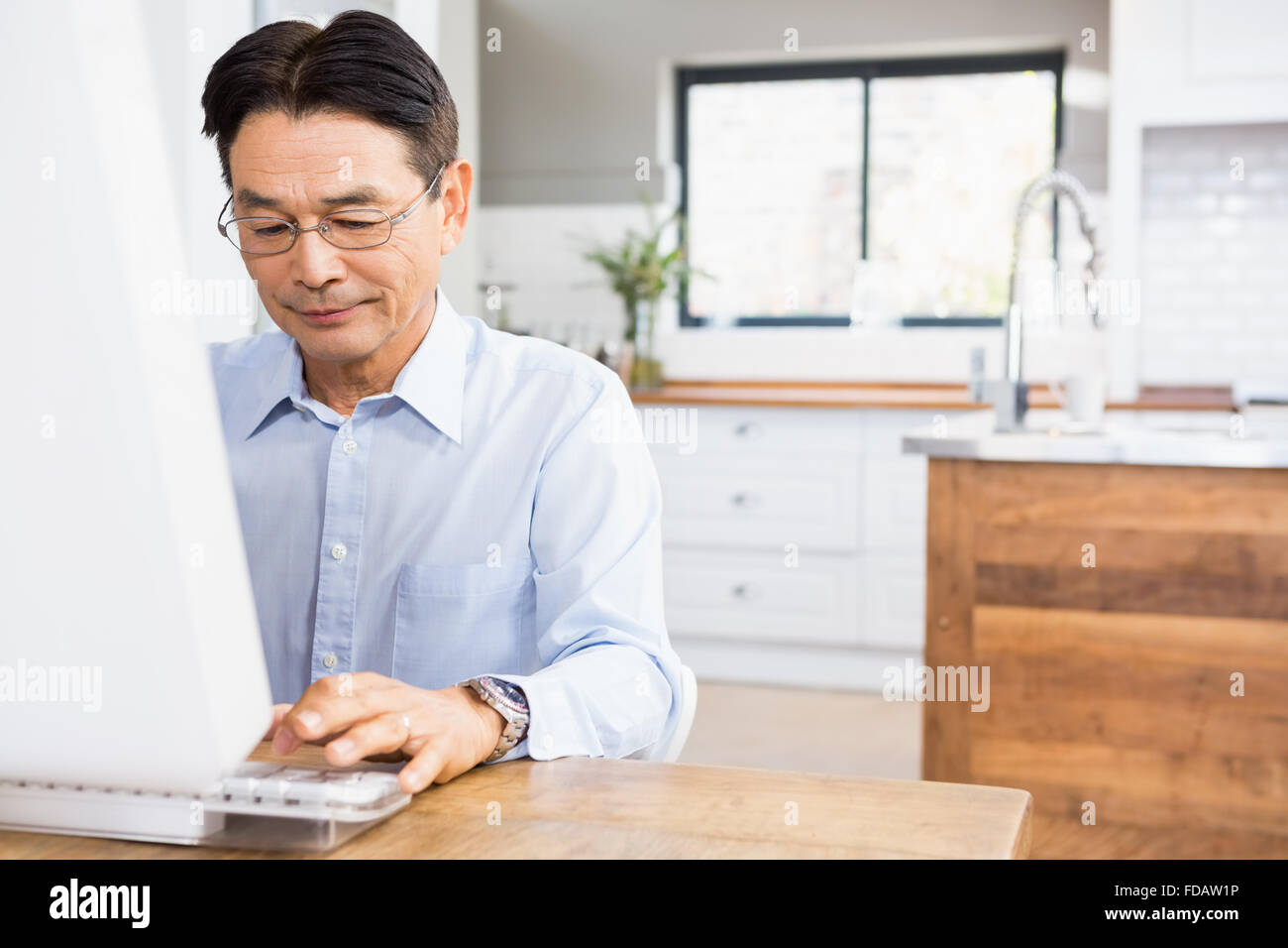 Smiling man using computer Stock Photo - Alamy