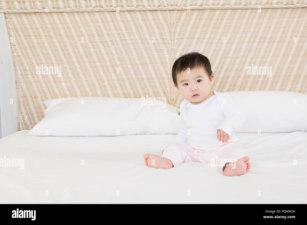 Cute baby on bed Stock Photo - Alamy