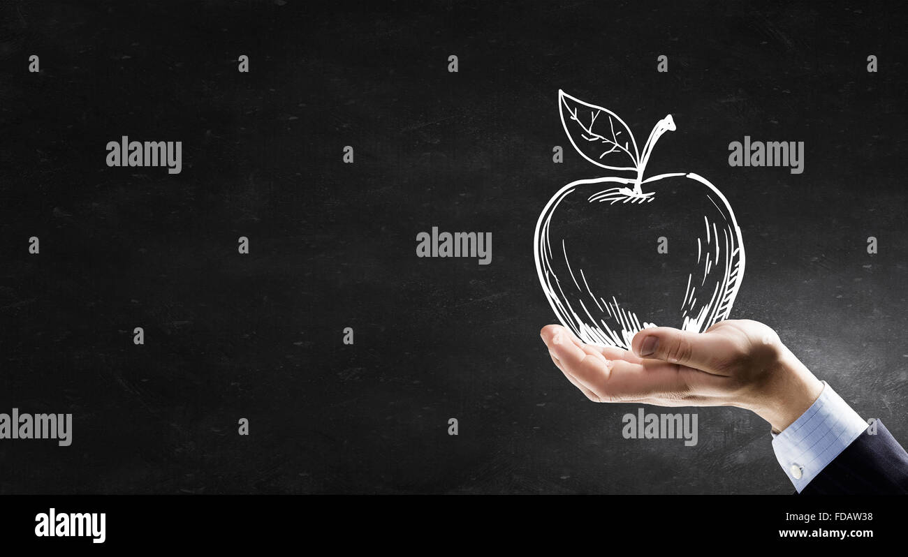Human hand holding apple drawn symbol in palm Stock Photo - Alamy