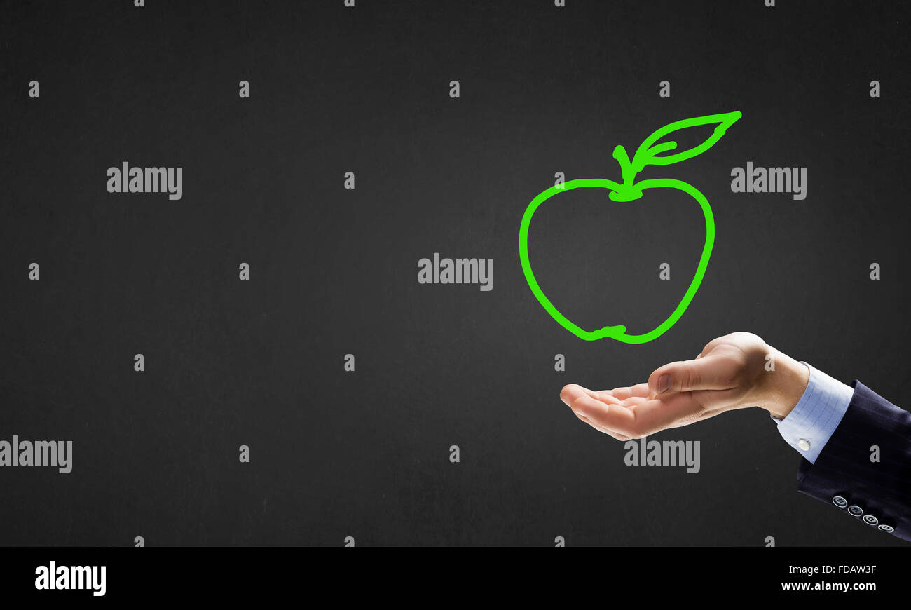 Human hand holding apple drawn symbol in palm Stock Photo - Alamy
