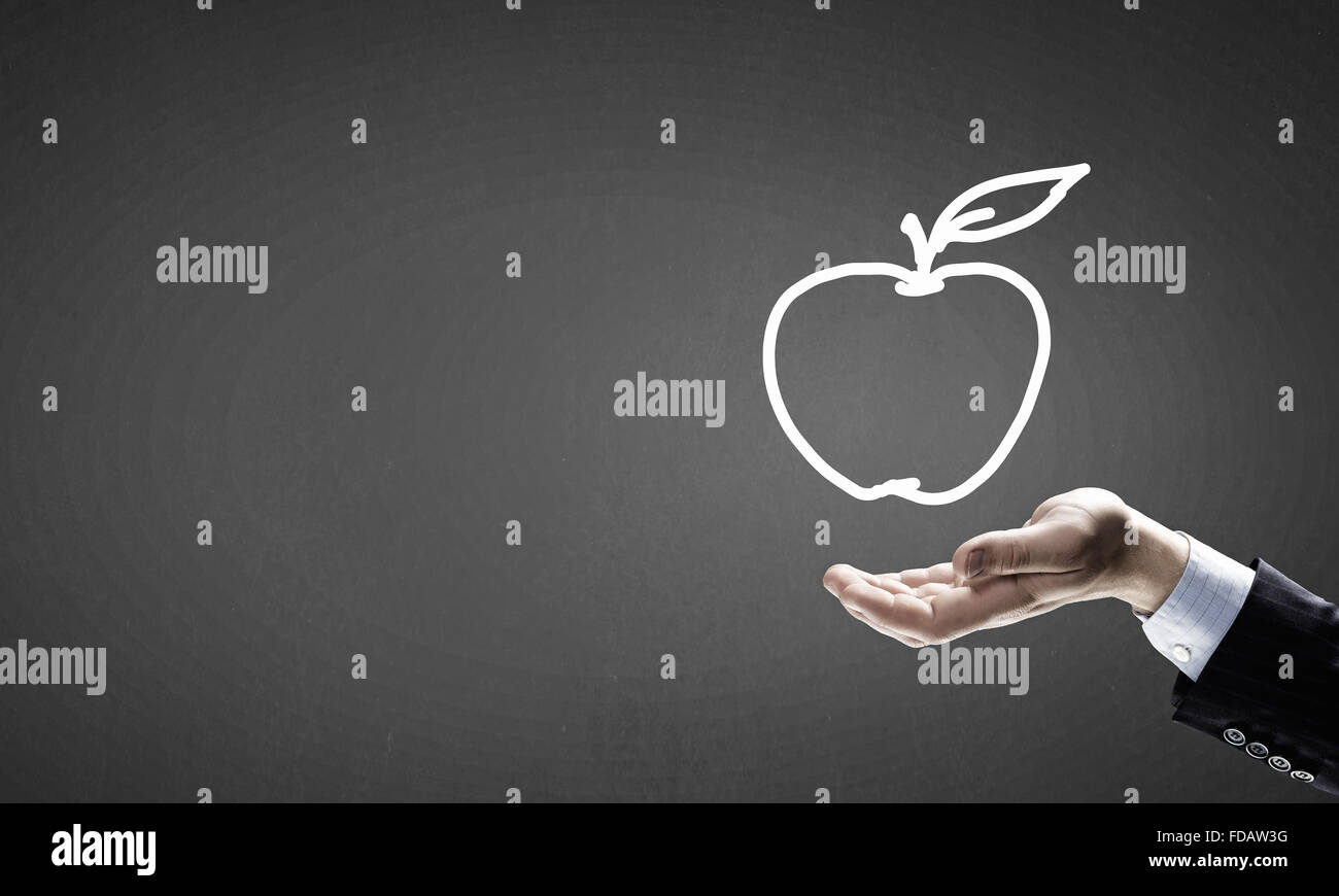 Human hand holding apple drawn symbol in palm Stock Photo - Alamy