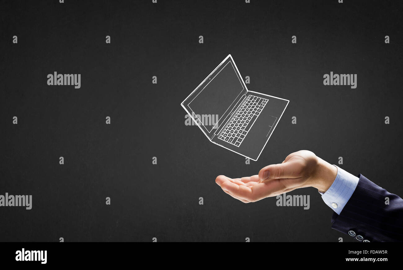 Human hand holding in palm laptop symbol Stock Photo - Alamy