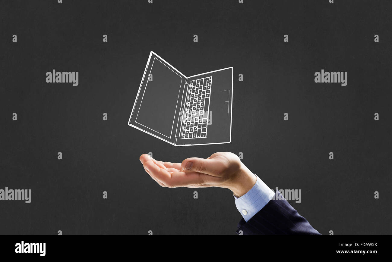 Human hand holding in palm laptop symbol Stock Photo - Alamy