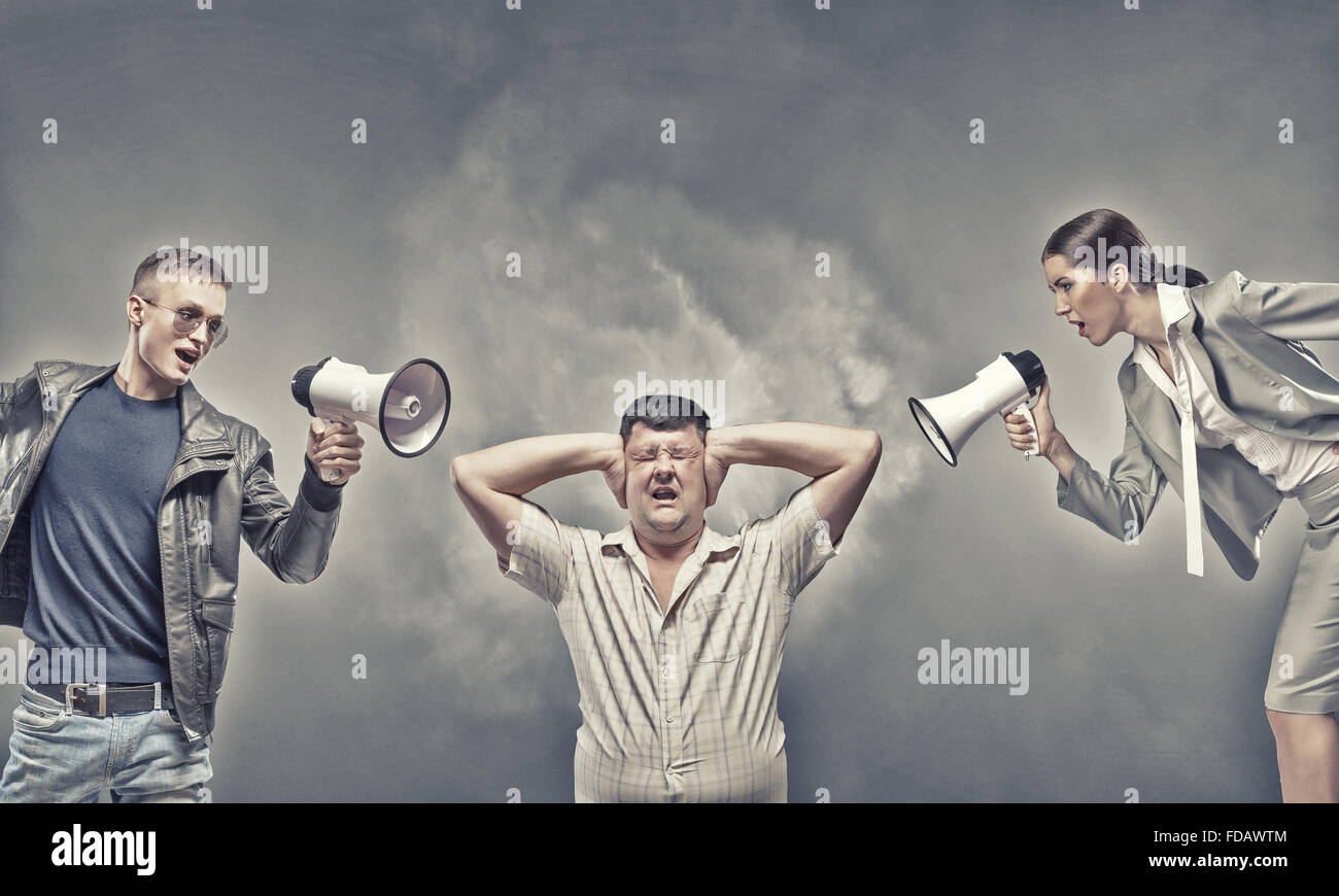 Furious people screaming agressively in megaphone at man Stock Photo ...