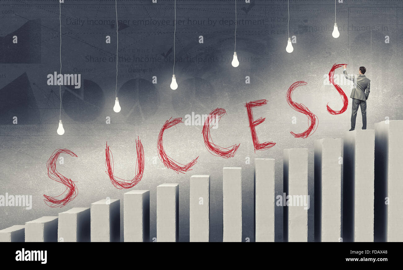 Back view of businessman on bars writing word success Stock Photo - Alamy