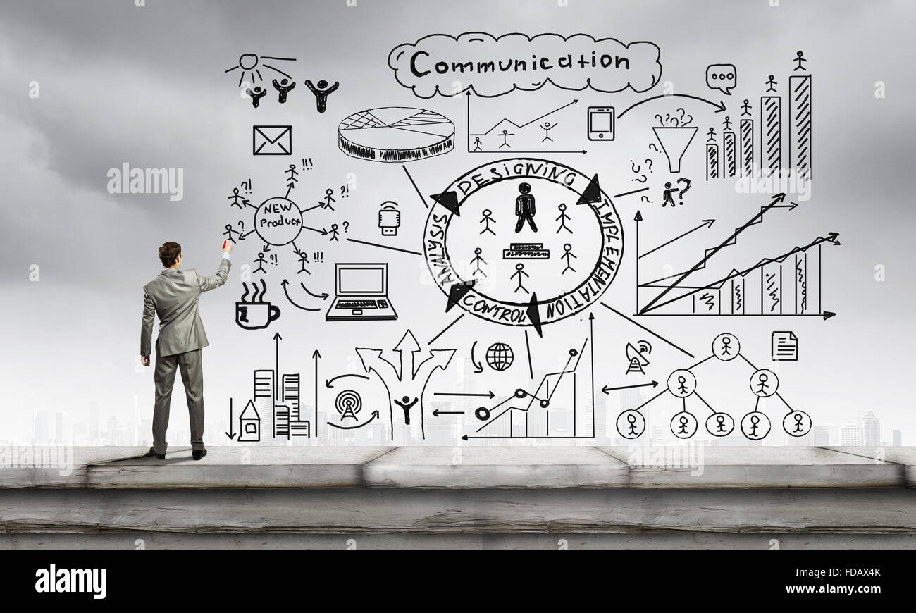 Back view of businessman drawing plan sketches on wall Stock Photo - Alamy