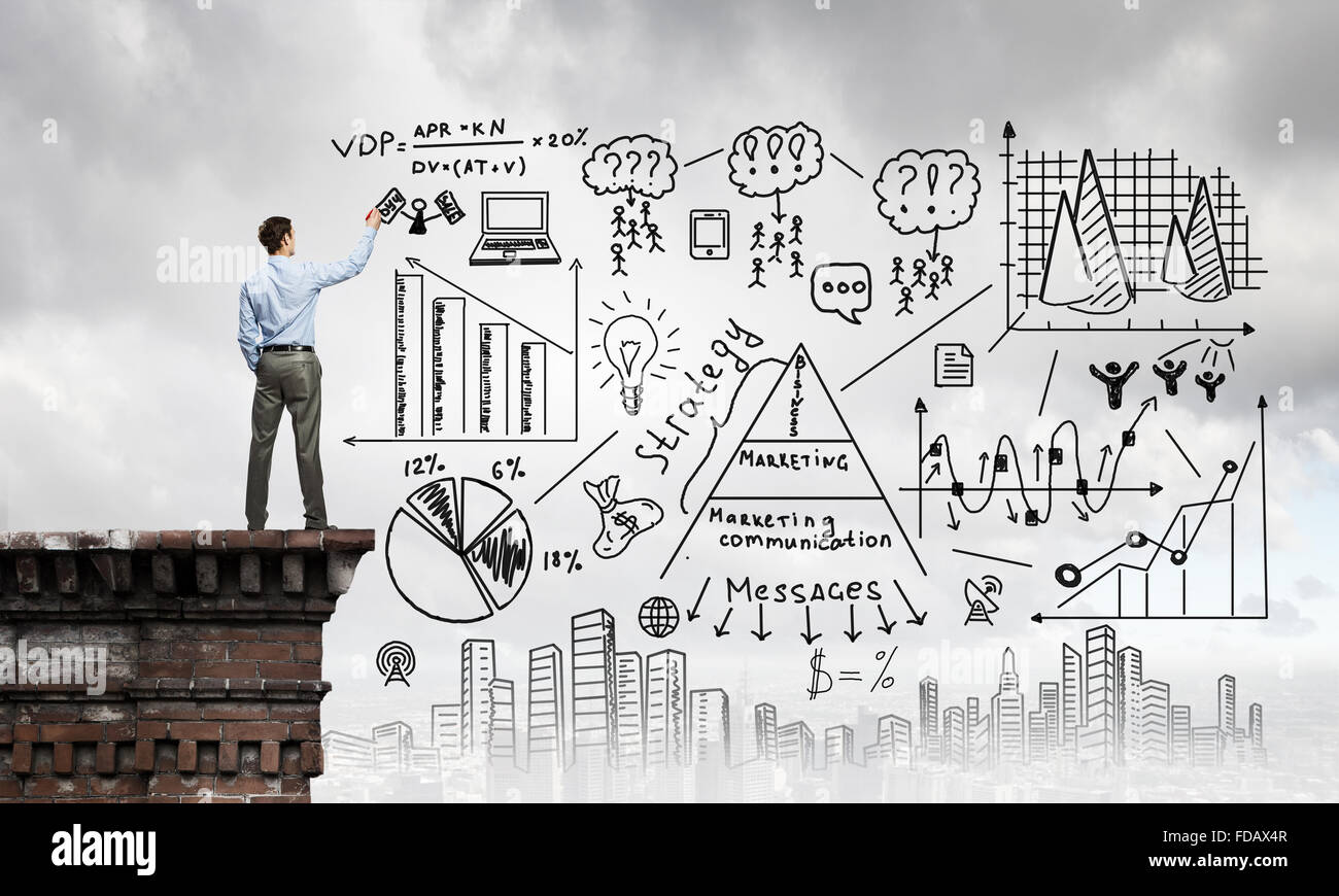 Back view of businessman drawing plan sketches on wall Stock Photo - Alamy