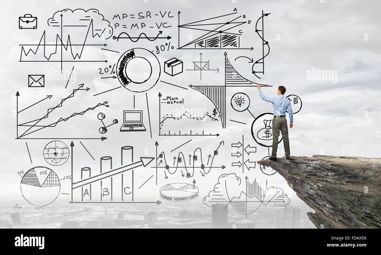 Back view of businessman drawing plan sketches on wall Stock Photo - Alamy