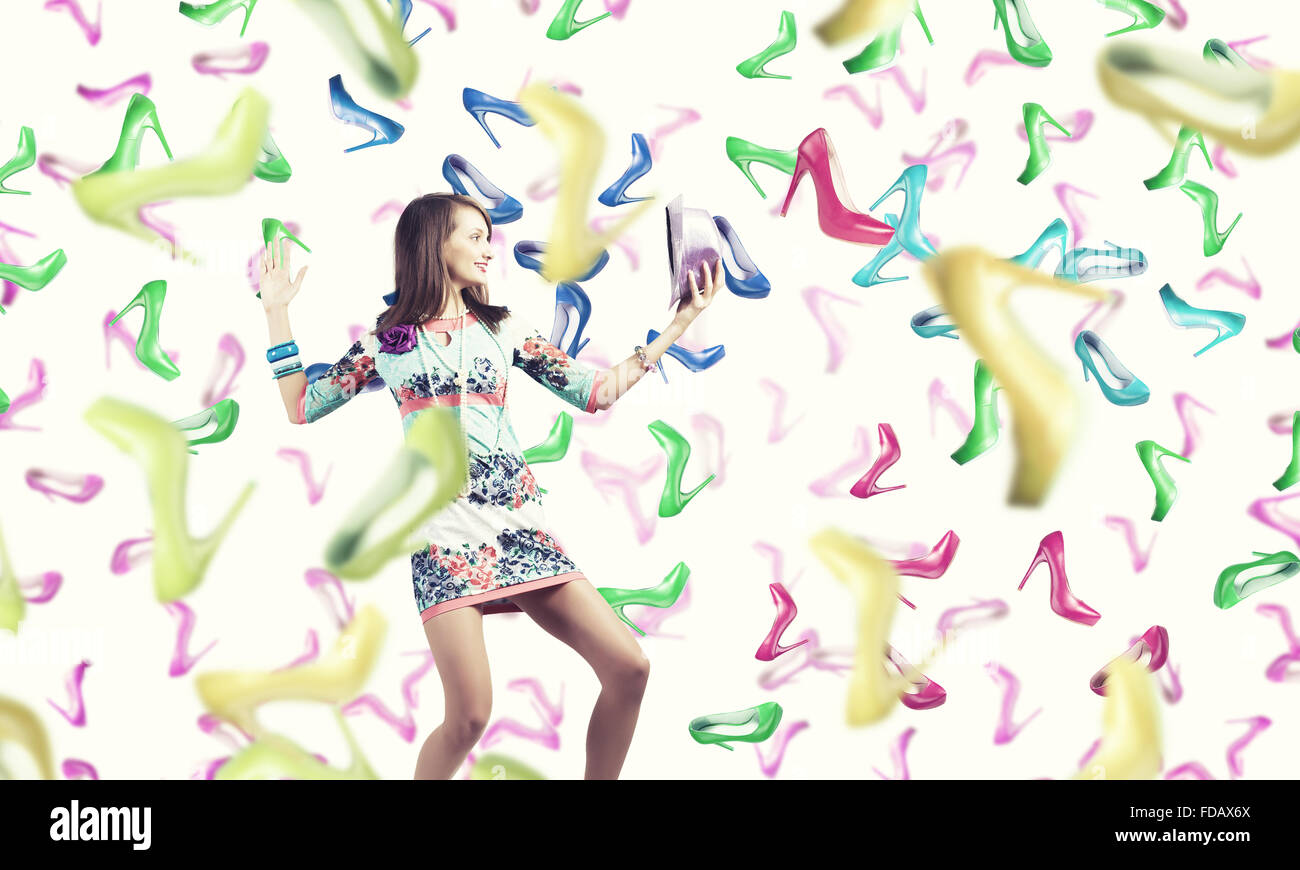 Young cheerful woman in dress and many falling shoes Stock Photo - Alamy