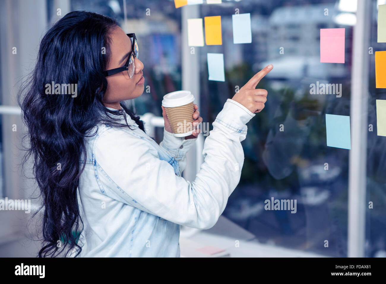 Asian woman pointing sticky note Stock Photo - Alamy