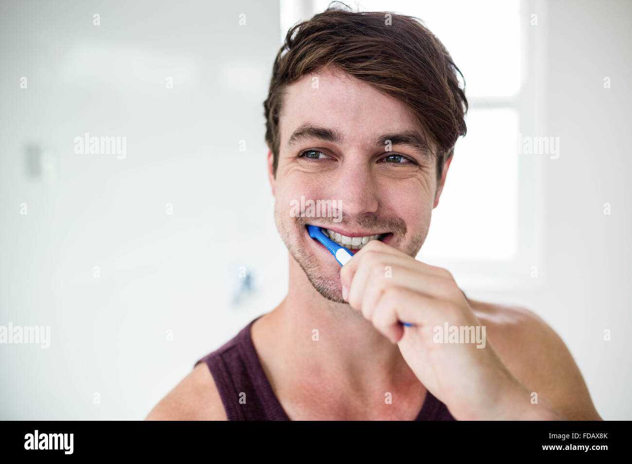 Handsome man cleaning his teeth Stock Photo - Alamy