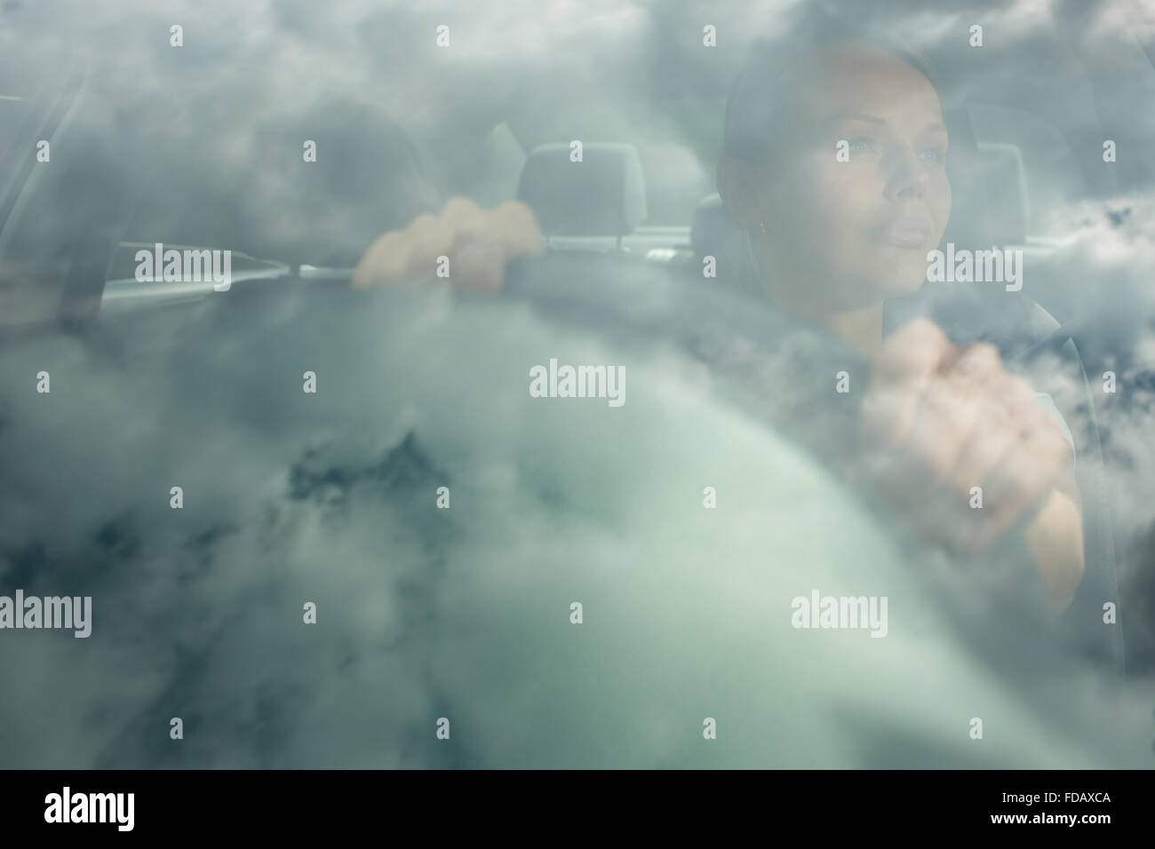 Young woman driving her car, on her way home from work - doing the ...