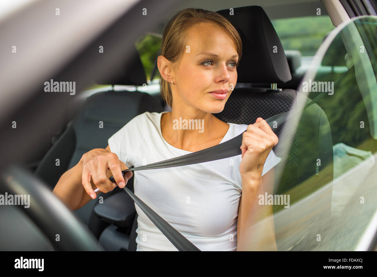 Young woman driving her car, on her way home from work - doing the ...