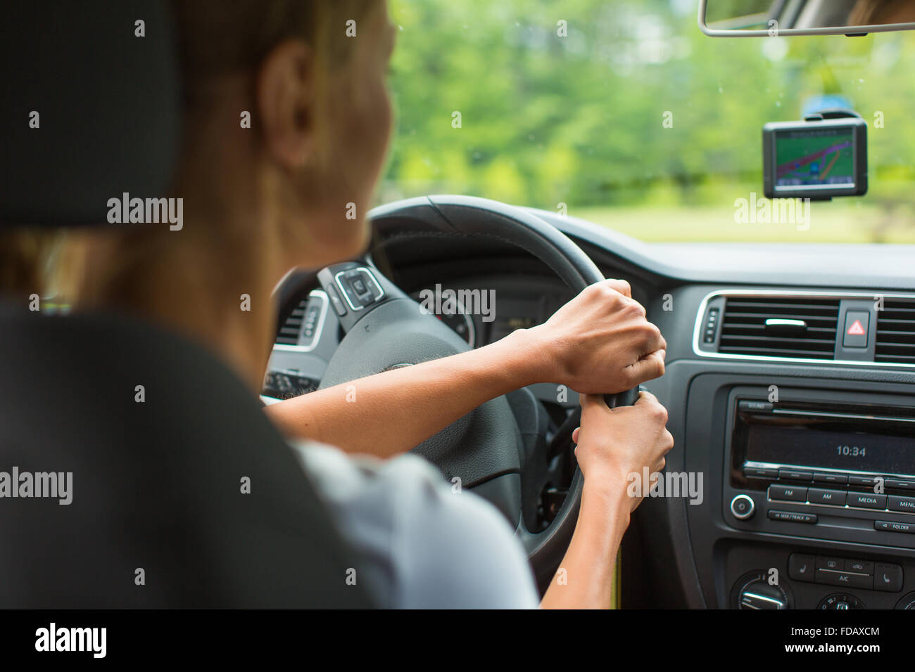Young woman driving her car, on her way home from work - doing the ...